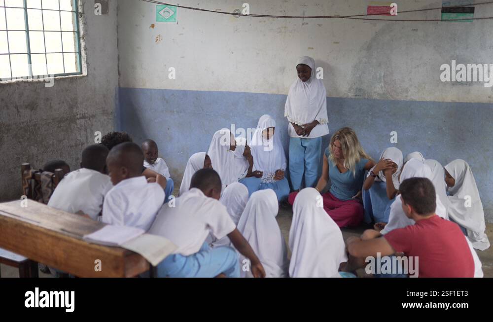 White volunteers teachers in class with african muslim children. Africa ...