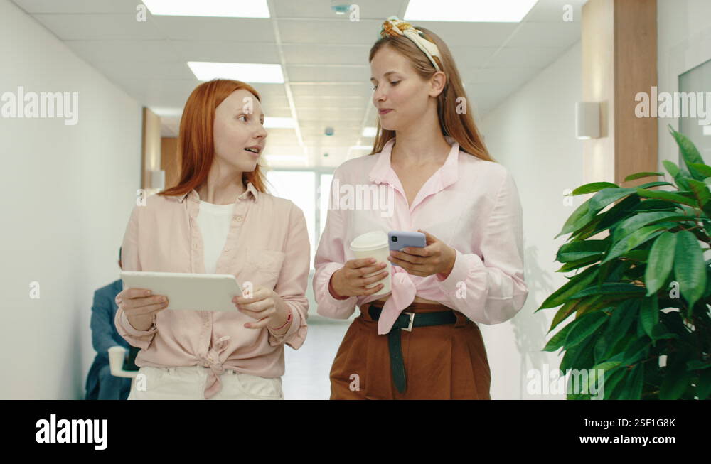 A Ginger Haired Woman And A Beautiful Tall Blonde Woman Are Walking