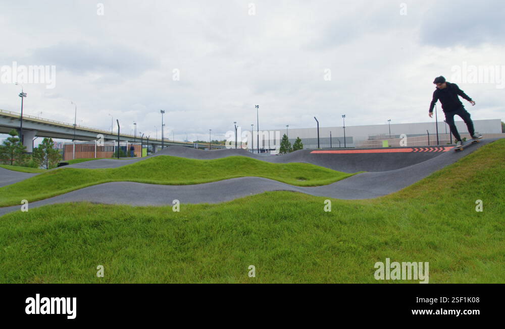 Guy rides skateboard on asphalt waves. Skatepark Stock Video Footage ...