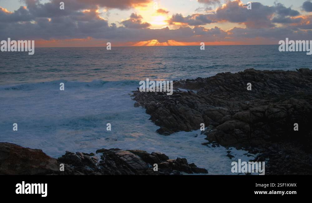 light rays at sunset over the ocean at Injidup beach Western Australia ...