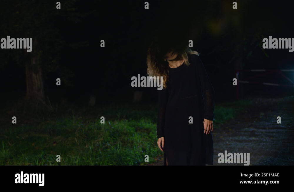 creepy woman looks at the camera, emerges from the darkness Stock Video ...
