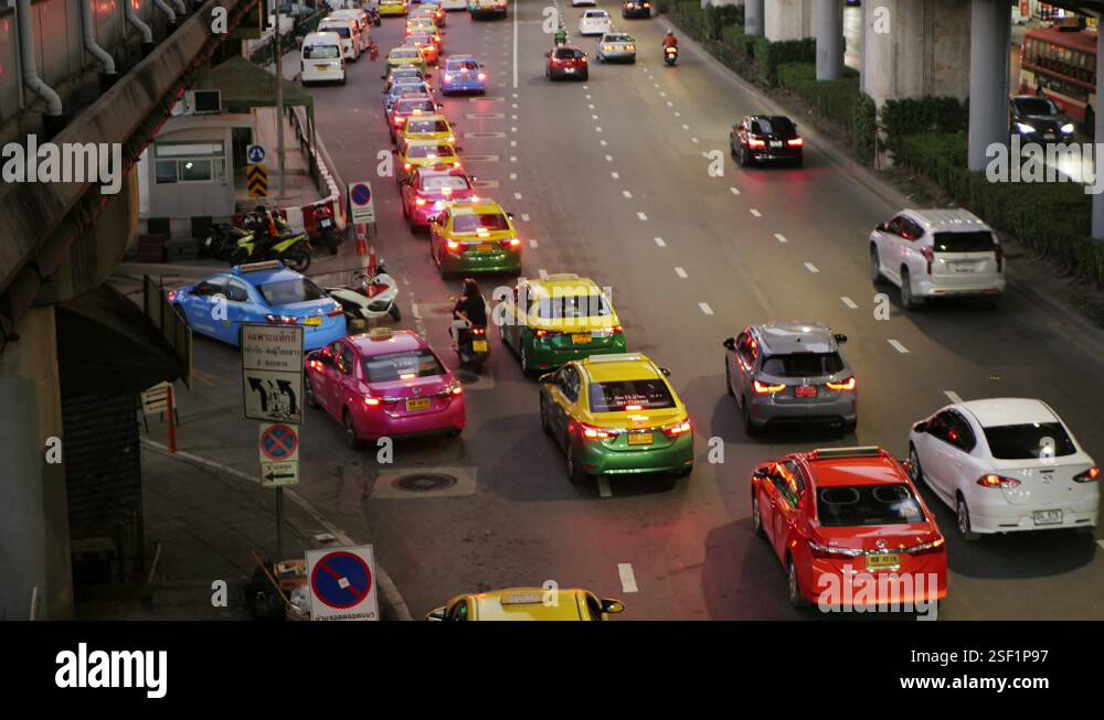 Yellow Taxis line up to pick up passengers in front of a shopping mall ...