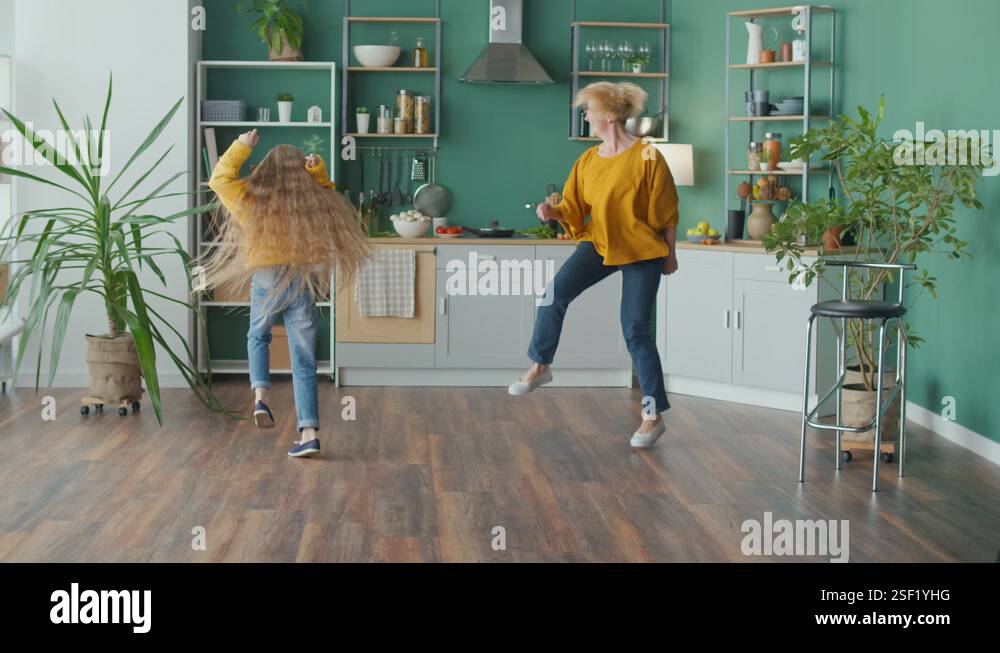 Cheerful Mom and Teenage Girl Jumping, Fooling Around, Having Fun ...