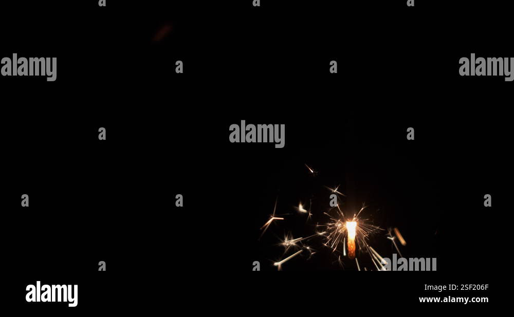 Close-up of a sparkler that burns completely in flames. Burning from ...