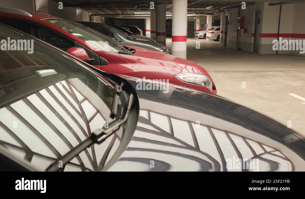 Cars parked inside a covered underground parking lot Stock Video ...