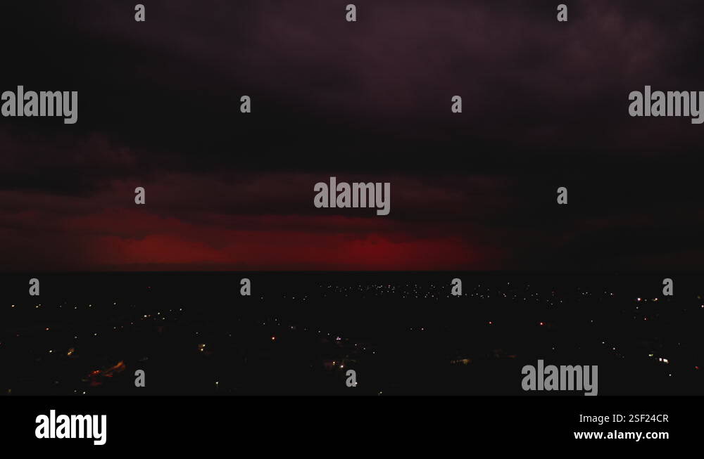 Fly above night city. Red clouds and seldom flash of lightning. Storm ...
