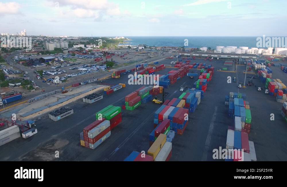Aerial forward over containers in Haina port logistic center and sea in ...