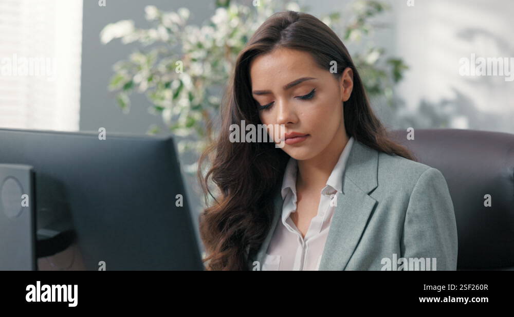 Pretty secretary of boss works in office at computer, enters data into ...