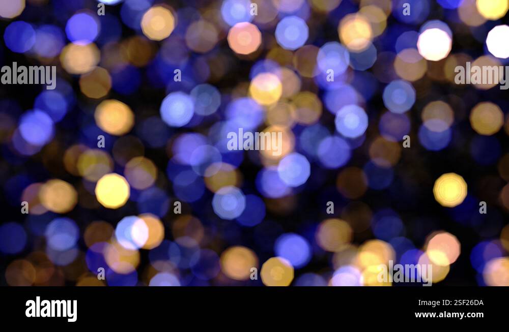 Blue and yellow shining light particles bokeh looping UHD animation ...