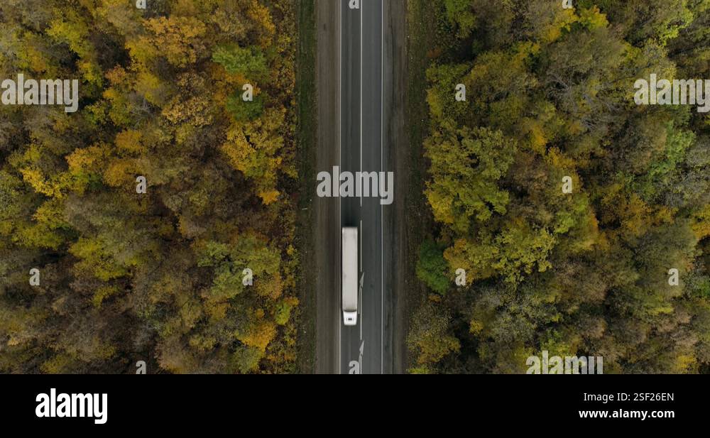 One Semi Truck with white trailer and cab driving, traveling alone on ...