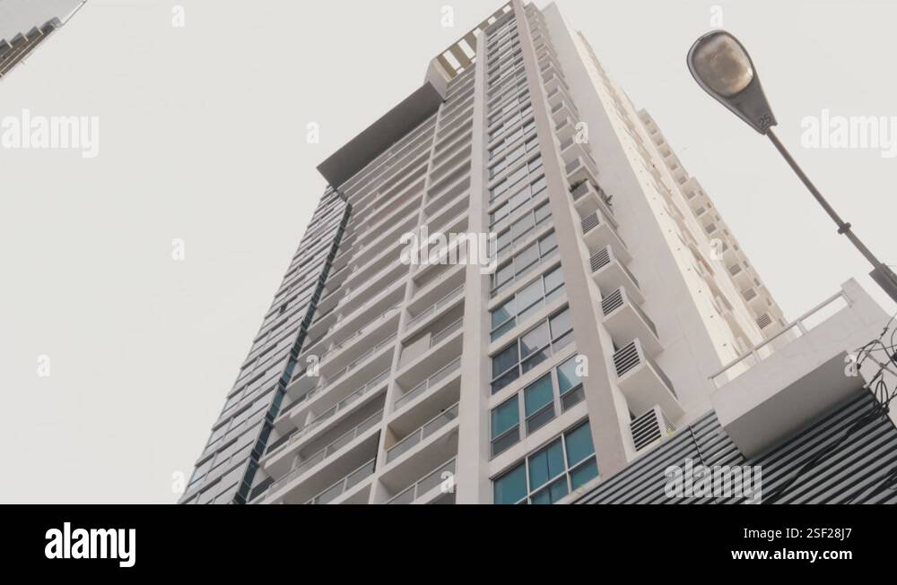A steep vertical tilt pan of a tall residential condominium, prime ...