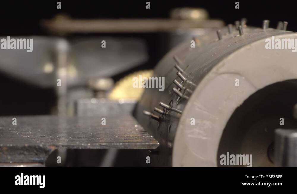 Close-up of a rotating drum of an old mechanical music box to play ...