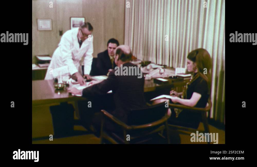 1970s: UNITED STATES: man with plans in meeting. SSS Headquarters ...