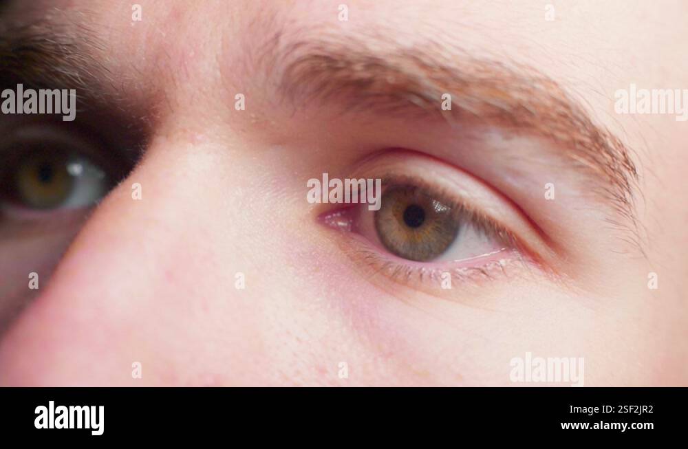 4K macro shot of a man opening his eyes in super slow motion, looking ...