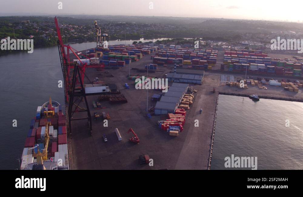 Many containers and mobile cranes at quay of Haina channel port ...
