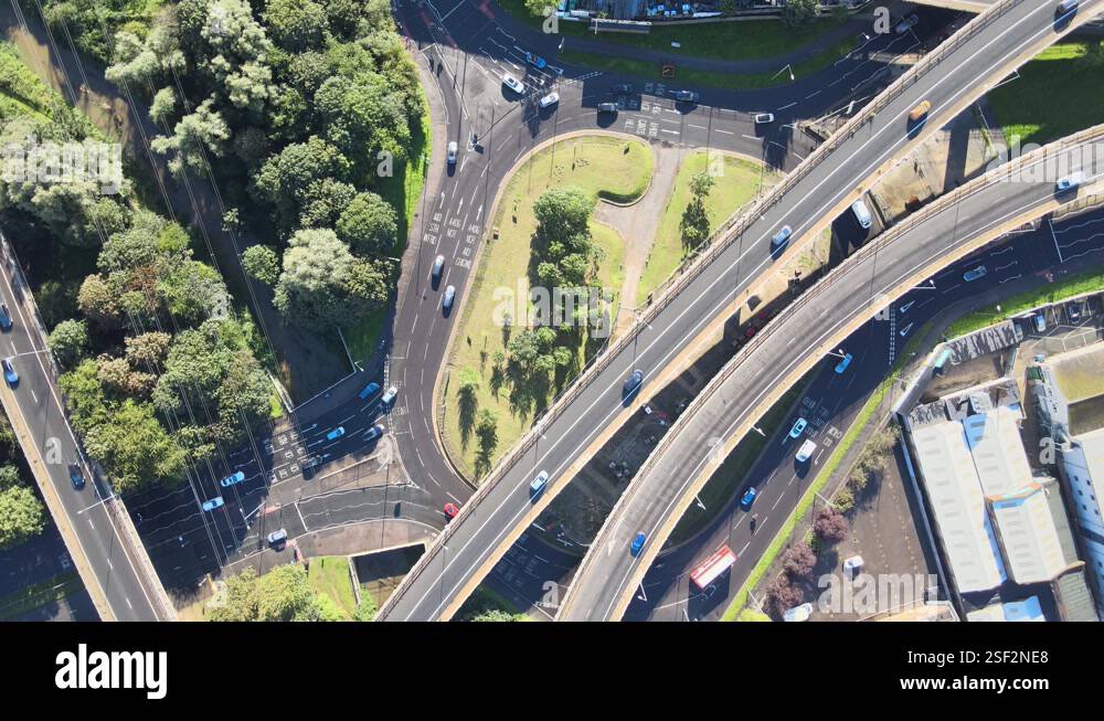Vehicles driving through roundabout under highway bridges Stock Video ...
