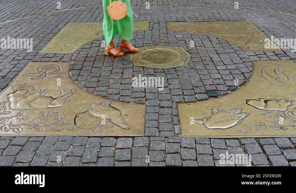 Girl in a dress walking on the paving stones at the symbol Stock Video ...