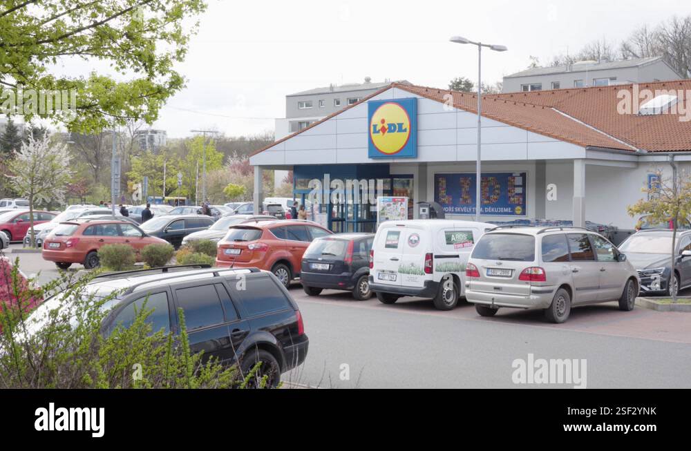 Entrance of a Lidl store with a parking lot in the foreground in an ...