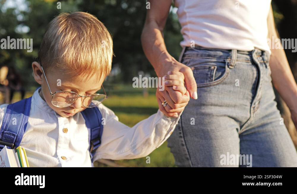 First time to school. Happy cute clever boy in glasses with school bag ...