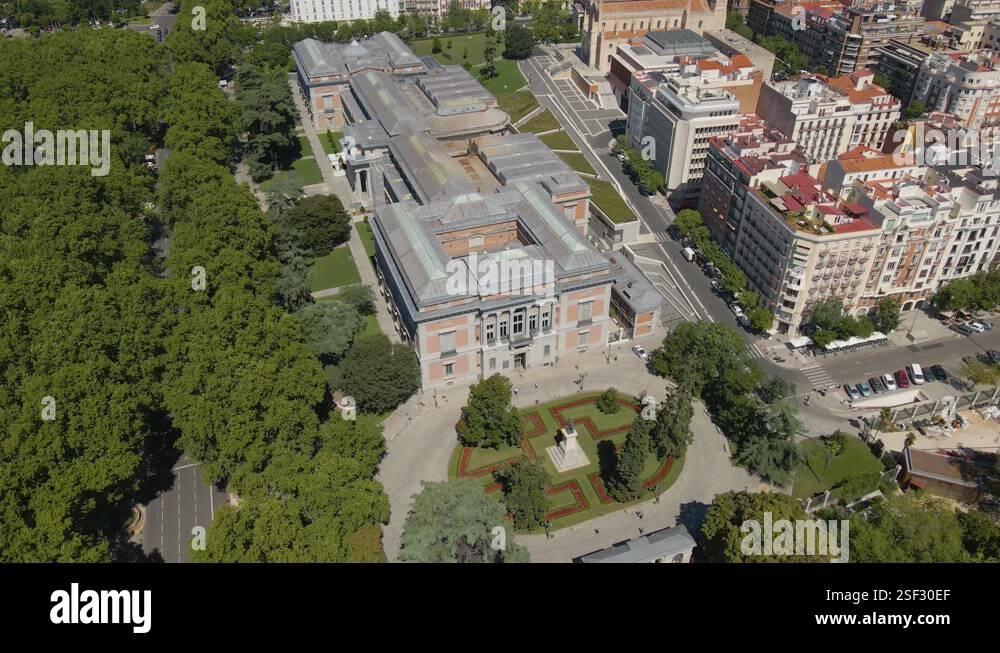 Aerial view of an old big building in Valencia with lots of trees ...