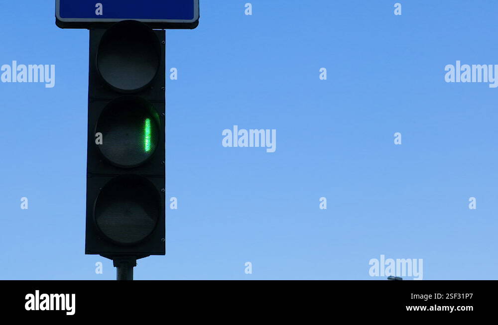 A red traffic light lit up against the sky Stock Video Footage - Alamy