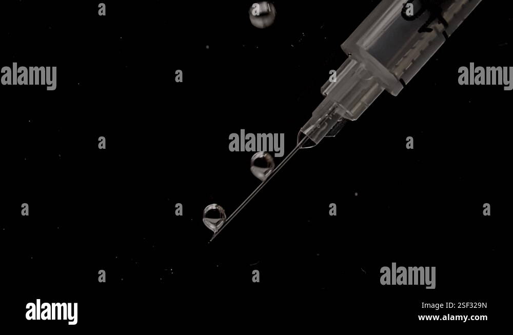 Syringe with medicine. Macro shot of Syringe with medicine in water and ...
