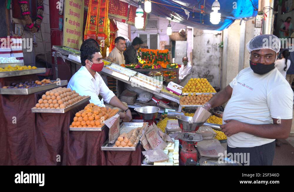 Static shot people buying sweets from a sweets shop outside Hanuman ...