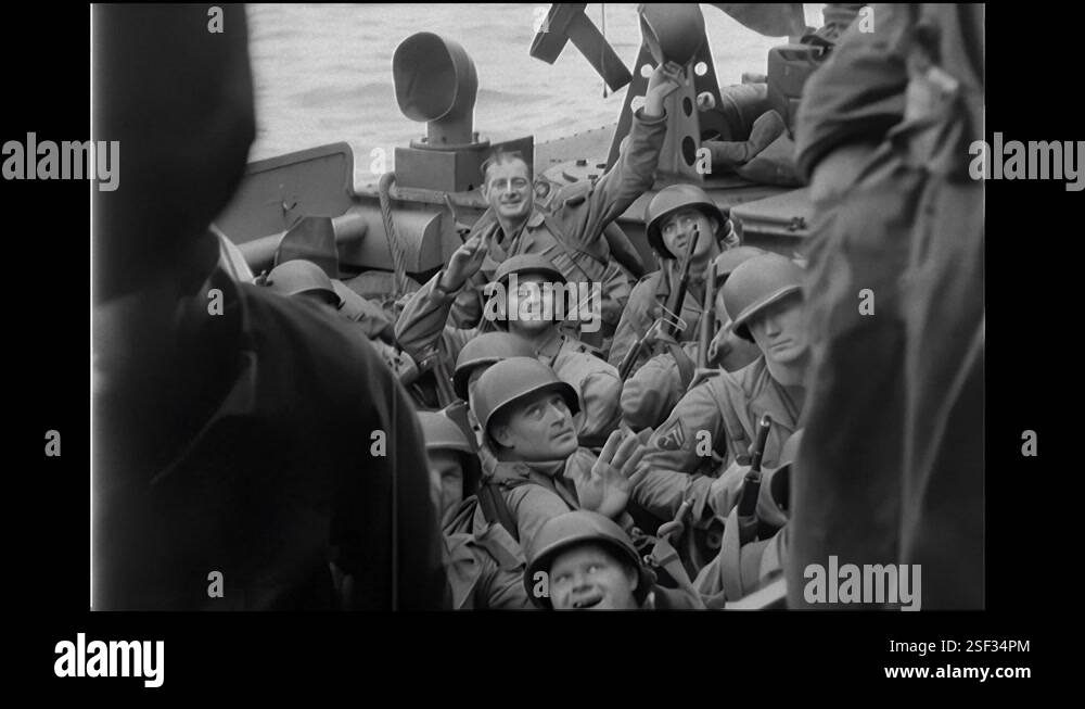 1940s: Soldiers climb onto transport boat. Soldiers wave. Boat moves ...
