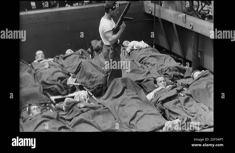 1940s: Ship. Men on stretchers on platform rise from ship's hold. Man ...