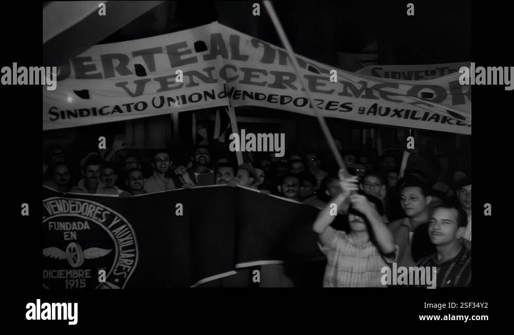 Cuba 1950s: Rally march at night holding signs and flags support the ...
