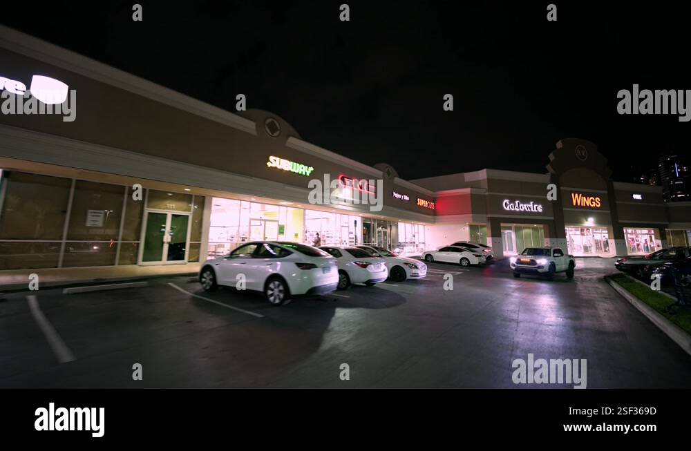 Busy shopping plaza at night 4k motion video Stock Video Footage - Alamy
