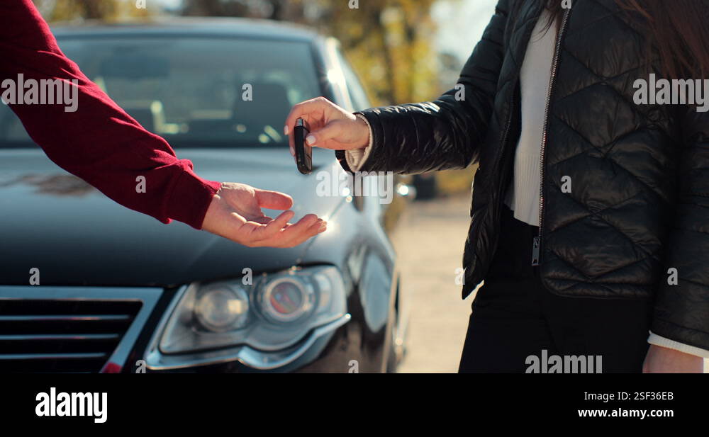 Man gets the car key from seller - satisfied - trade closed - new car ...