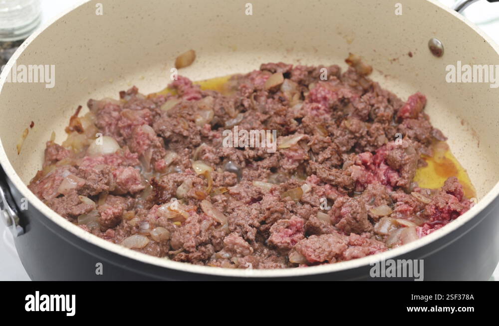 Fried ground beef and chopped onion close up on frying pan Stock Video ...