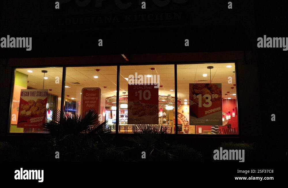 Popeyes fried chicken restaurant exterior people inside through window ...