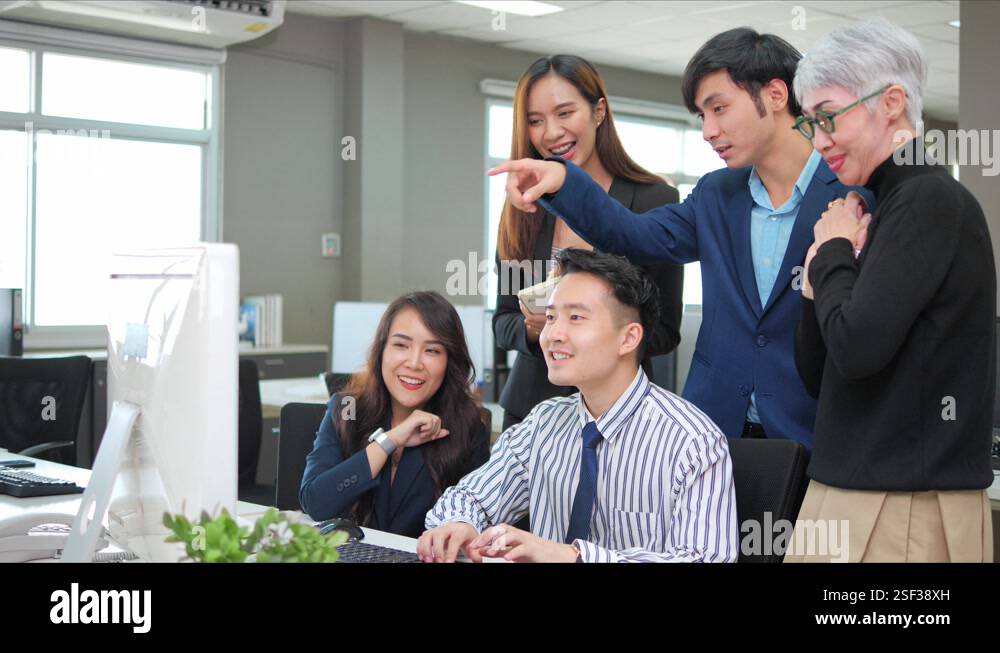 Smiling young asian business team employees and senior female executive ...