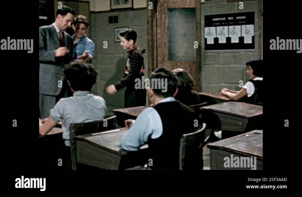 1950s: Kids in classroom, boys stand, walk to teacher, teacher points to boy's Stock Video ...