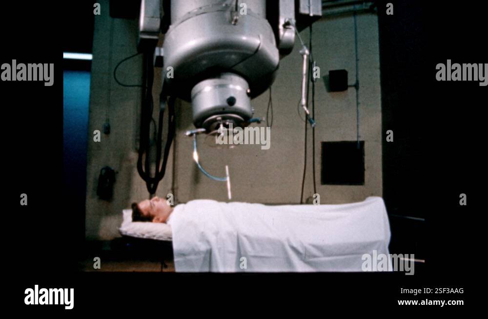1960s: Nurse preps patient for x-ray in hospital. Energy waves chart ...