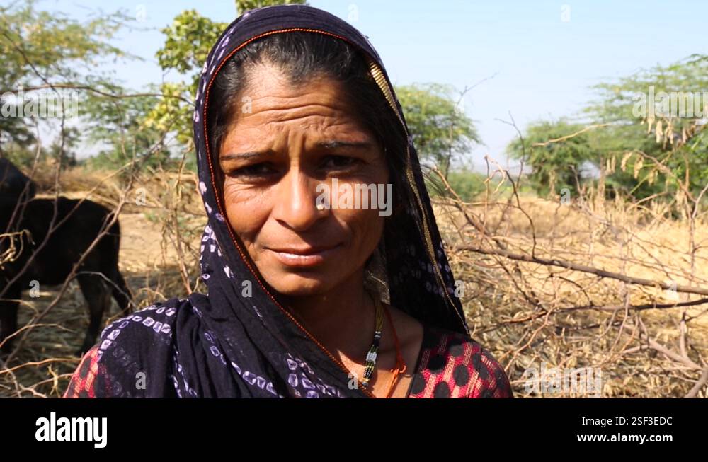 Authentic handheld portrait of farmer Indian woman from rural village ...