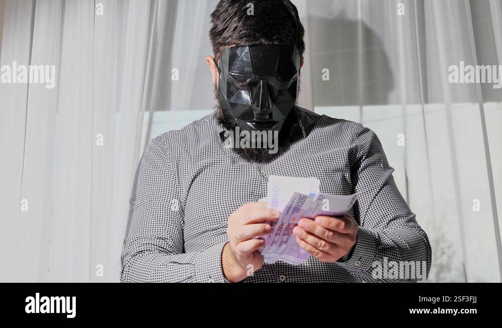Contrabandist wearing mask, counting Euro cash notes banknotes pointing ...