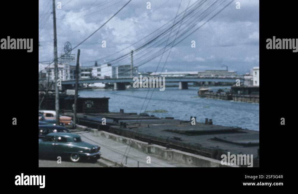 1950s: Person holds shooting slate. City. Barge near bridge. Farmer and ...