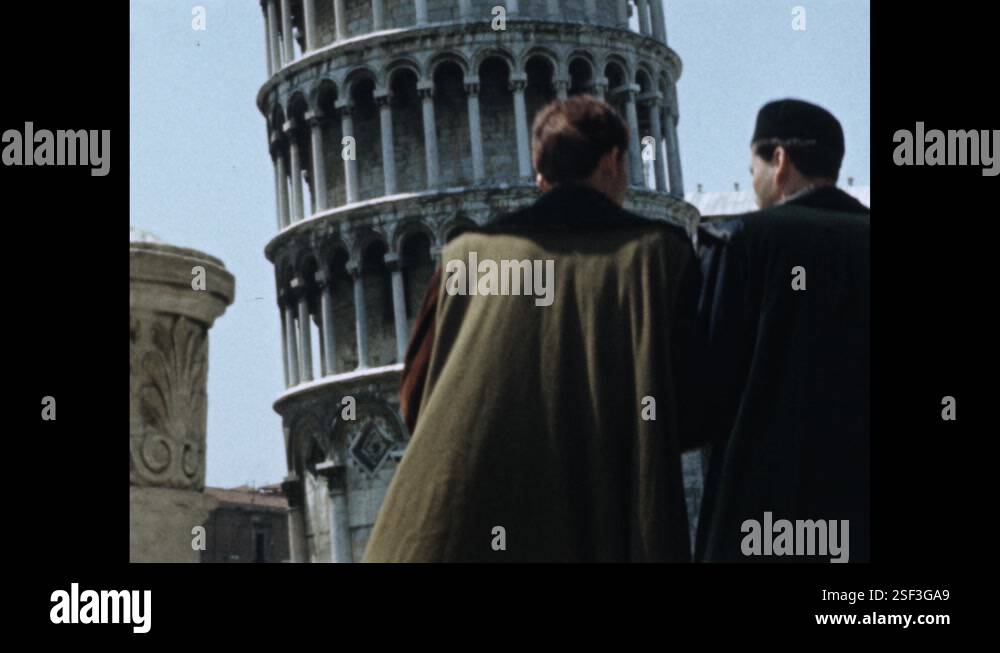 1800s: Two men in cloaks walk past Leaning Tower of Pisa. The men stand ...