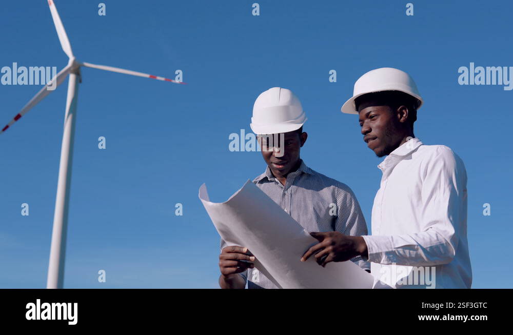 Two male African American electrical engineers stand against the ...