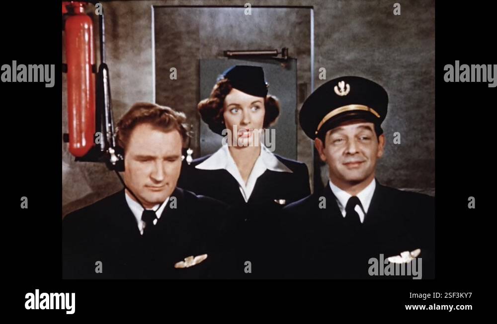 1950s: Stewardess talks to pilots in cockpit of plane. Stewardess ...