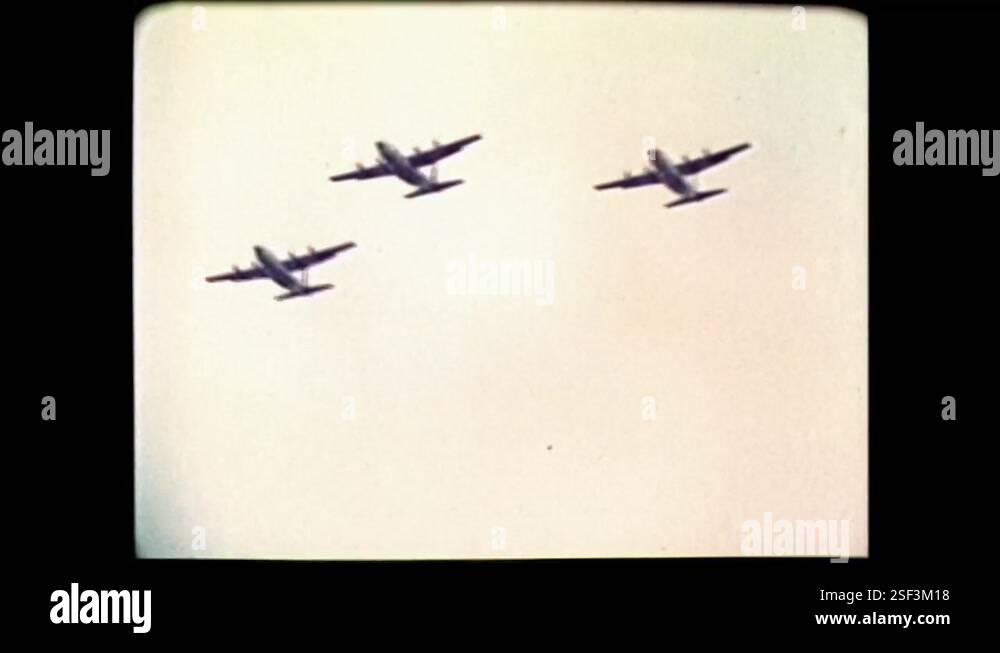 1960s: Pilots fly formation of cargo planes through sky. Paratroopers ...