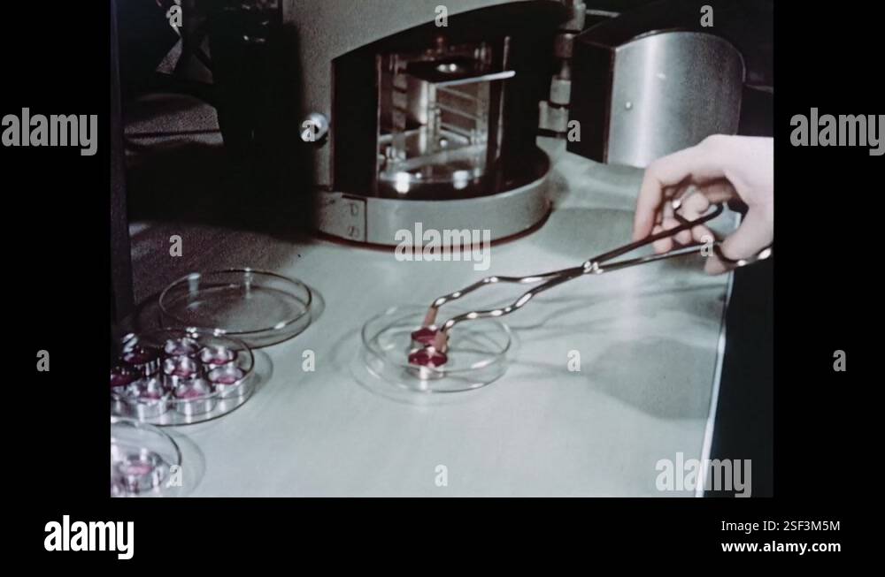 1950s: Woman places radioactive teeth in Geiger counter with forceps ...