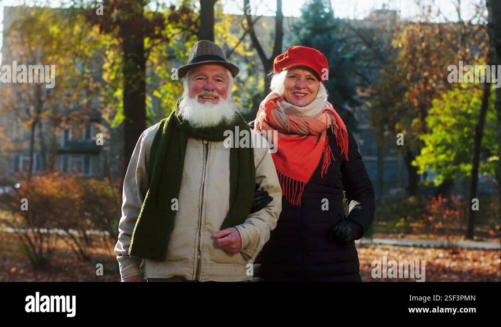 Very casual and charismatic old couple in a large park in the cold au ...