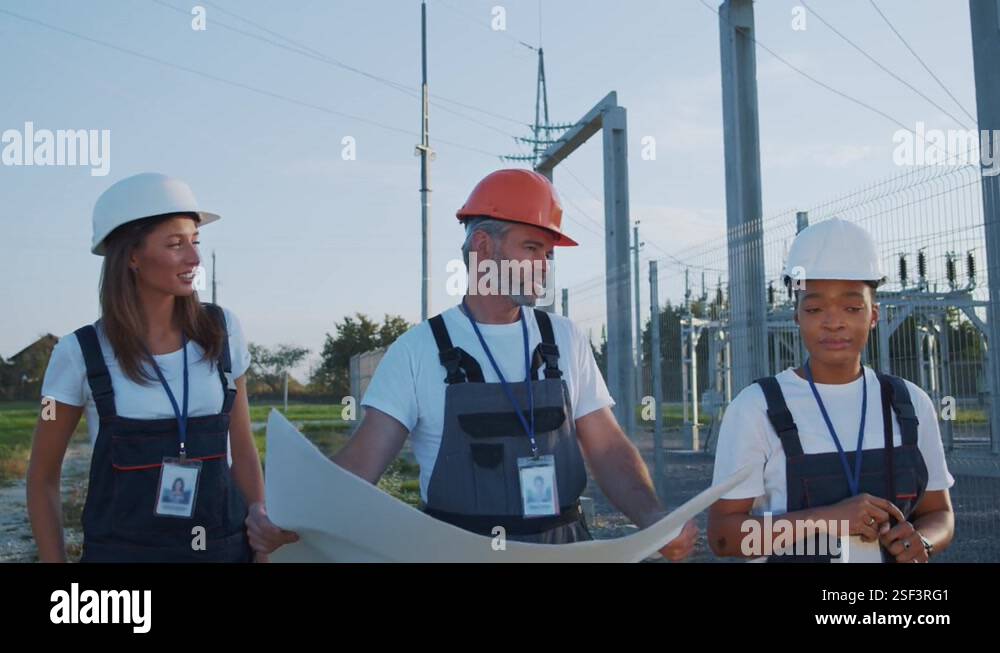 Power plant workers. Male architect and two multi-ethnic smart female ...