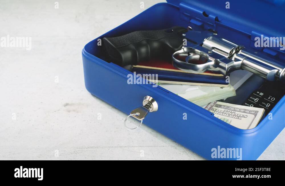 Spy unlock the metal safe box and takes a gun and puts the Data Disk ...