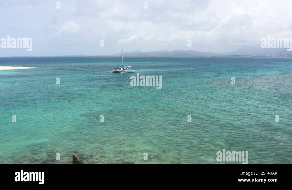 AERIAL - People at a boat party, Cayo Lobos, Fajardo, Puerto Rico, wide ...