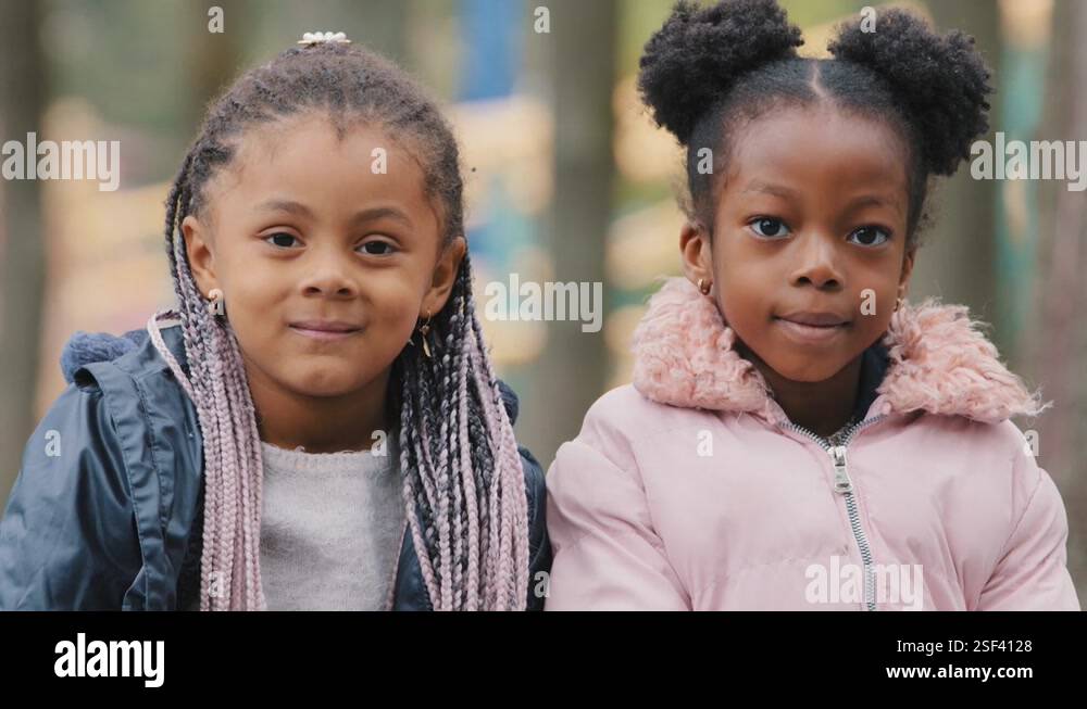 Portrait preteen cute children close-up two sisters spend time in city ...